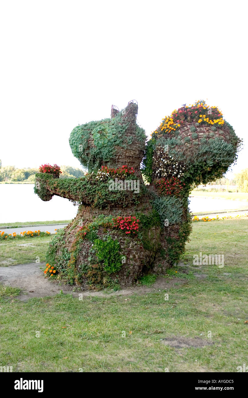 Squirrel shrubbery statue that holds flower at Zalew Tatar Lagoon and ...