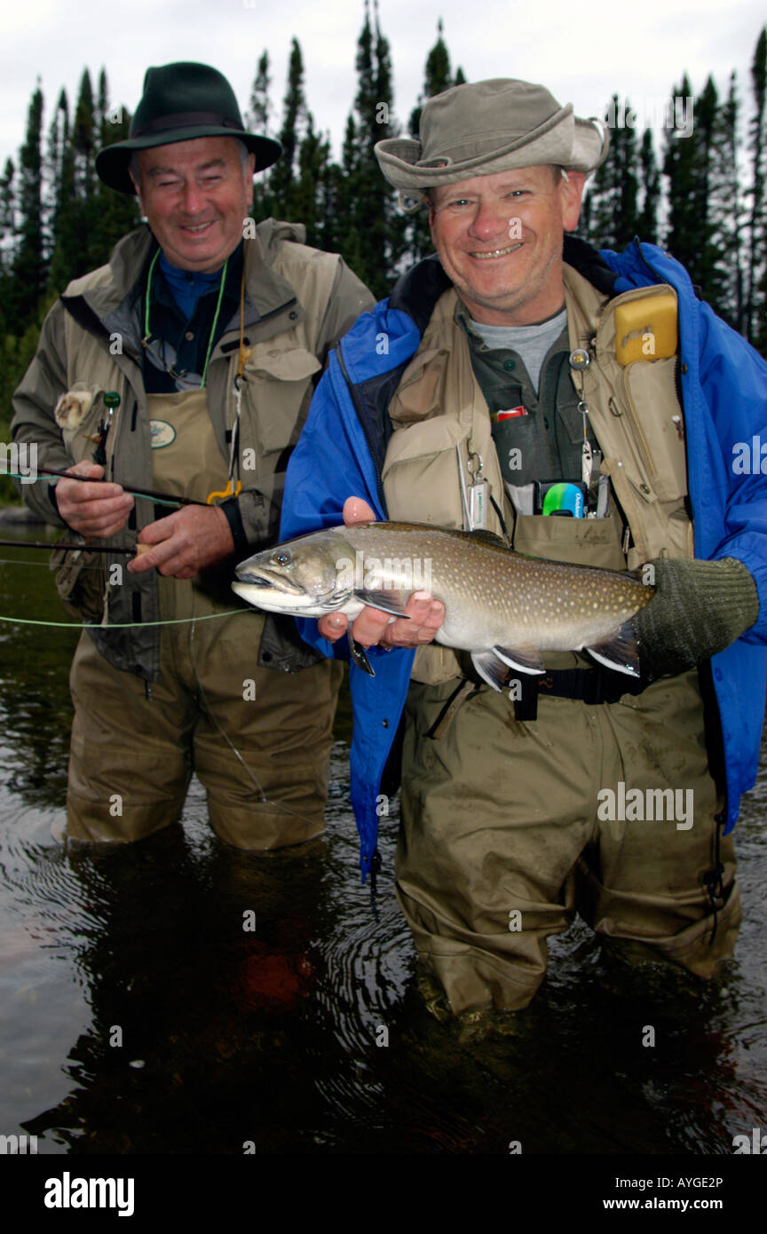 two men with large fish fly fishing Stock Photo - Alamy
