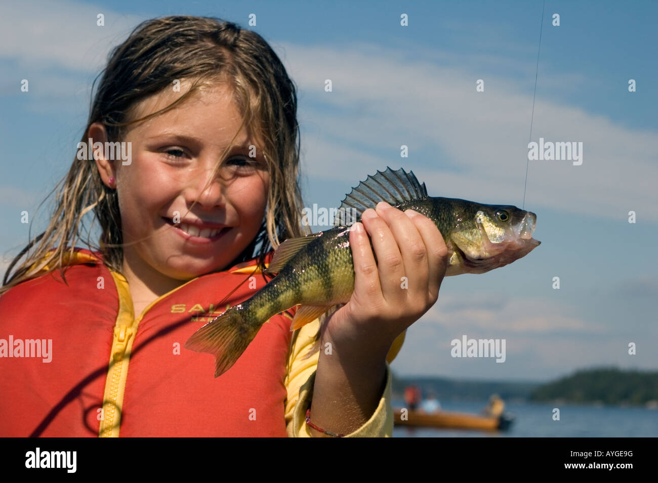 young girl with small fish Stock Photo - Alamy