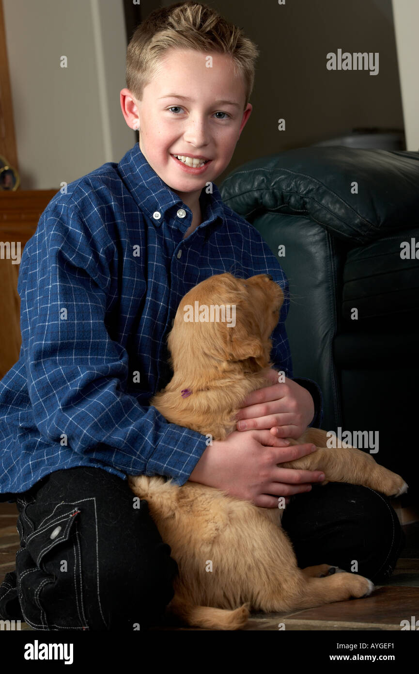 Boy hugging golden retriever puppies hi-res stock photography and ...
