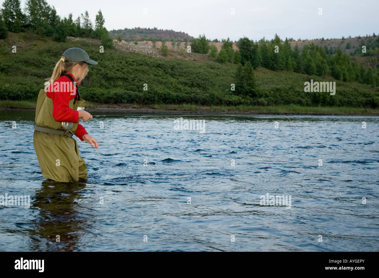 young lady fly fishing canadian river Stock Photo - Alamy