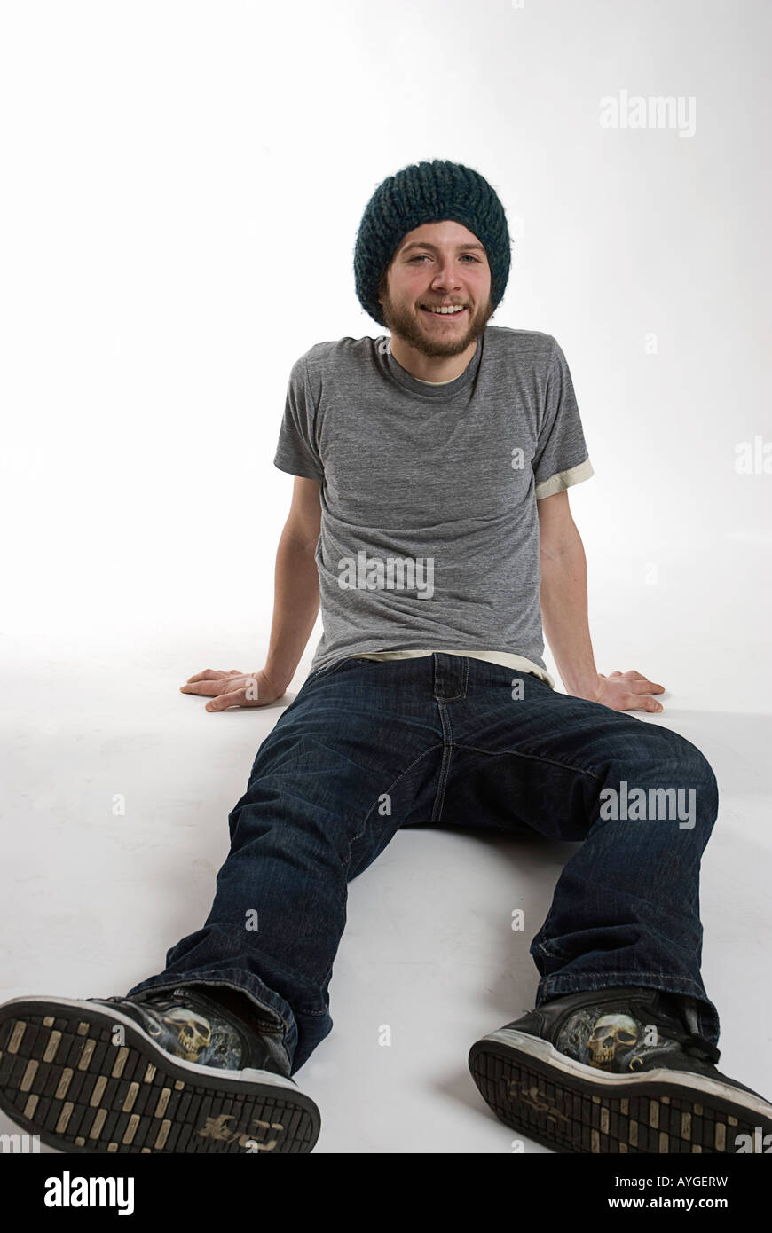 Young grunge guy sitting on the floor Stock Photo - Alamy