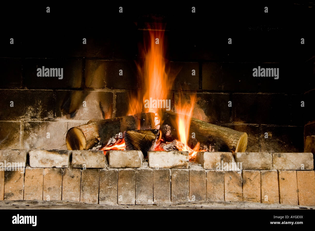 Log fire in an open fireplace Stock Photo - Alamy