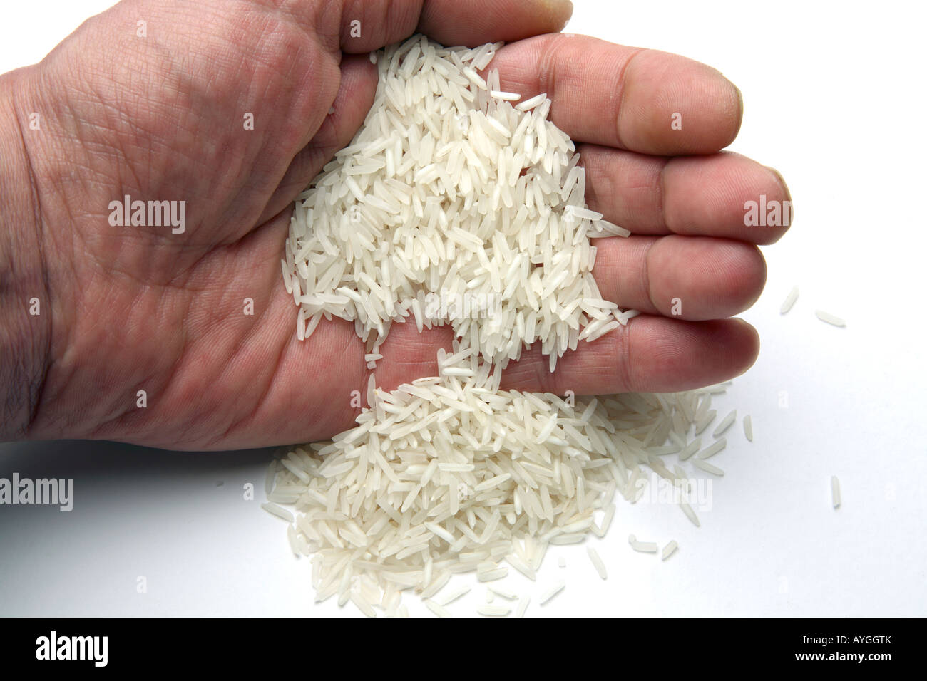 Hand and rice Stock Photo - Alamy