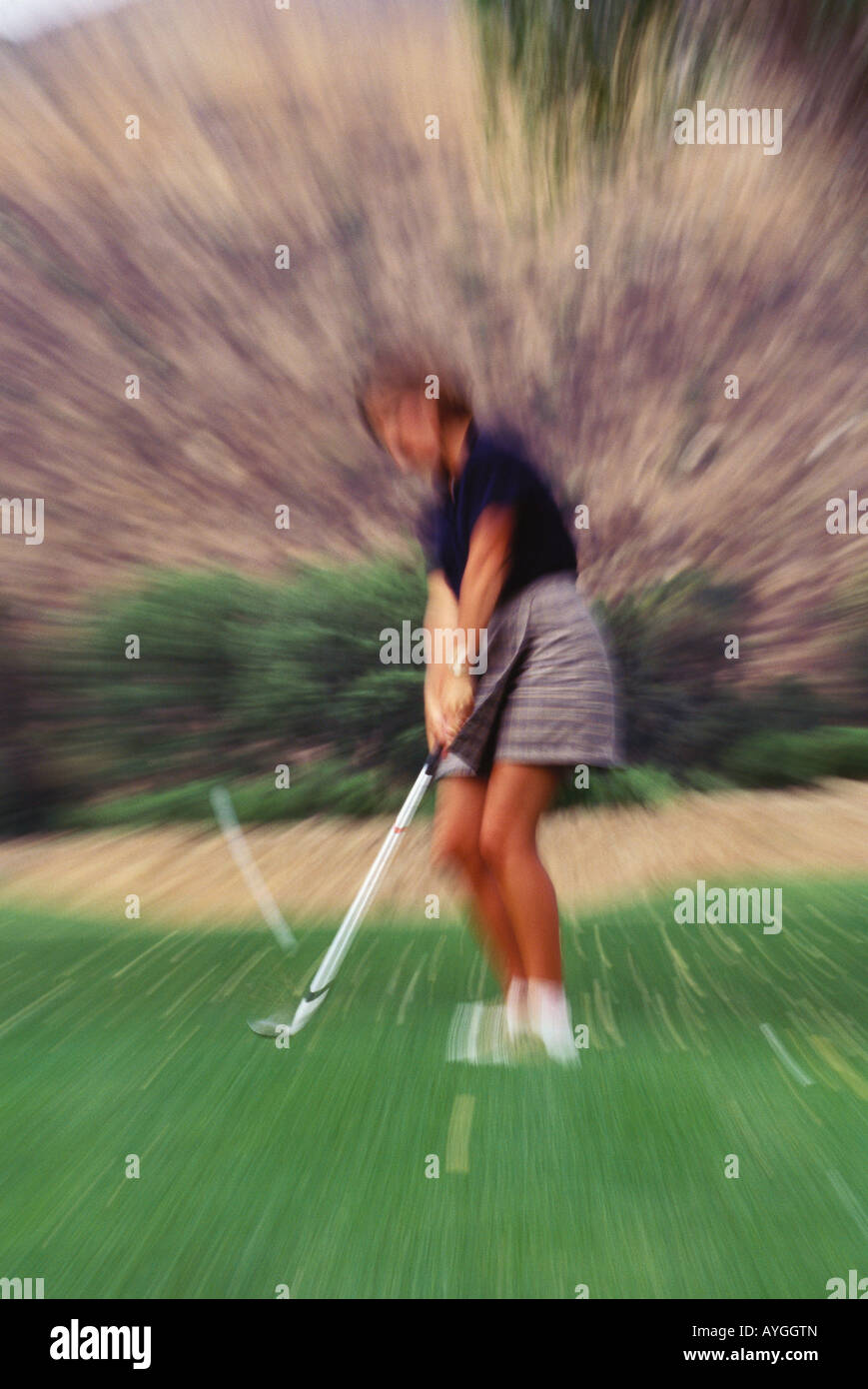 Woman golfer in action Stock Photo - Alamy