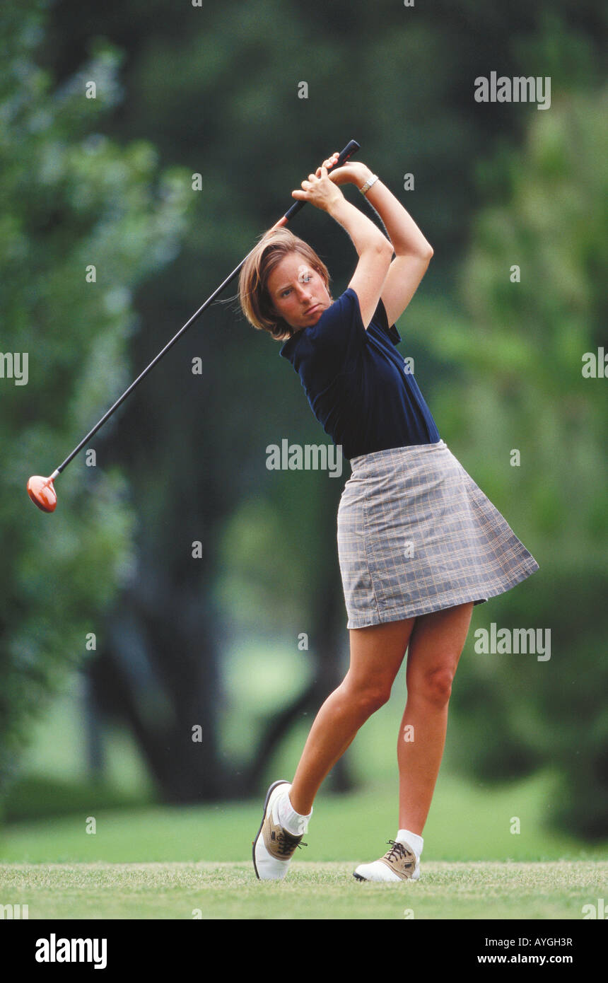 Woman golfer in action Stock Photo - Alamy