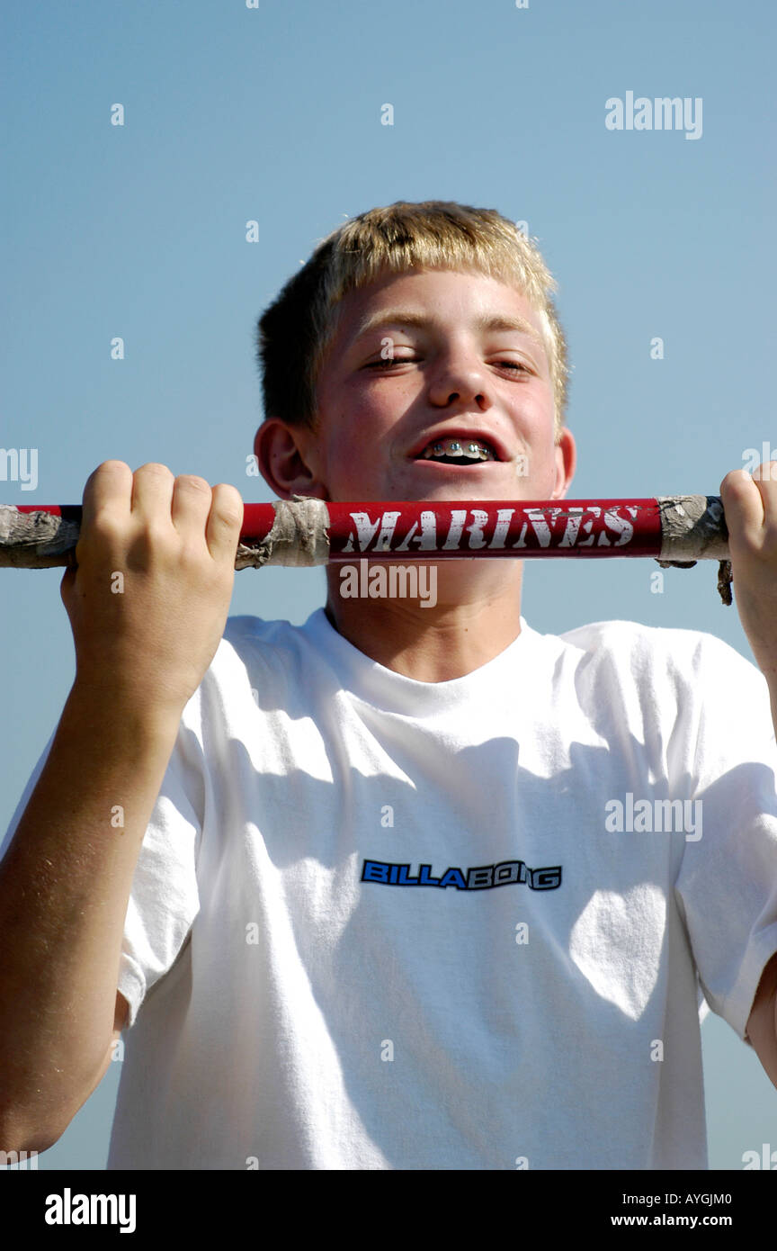 Boy doing a series of pull ups for a fitness test Stock Photo - Alamy