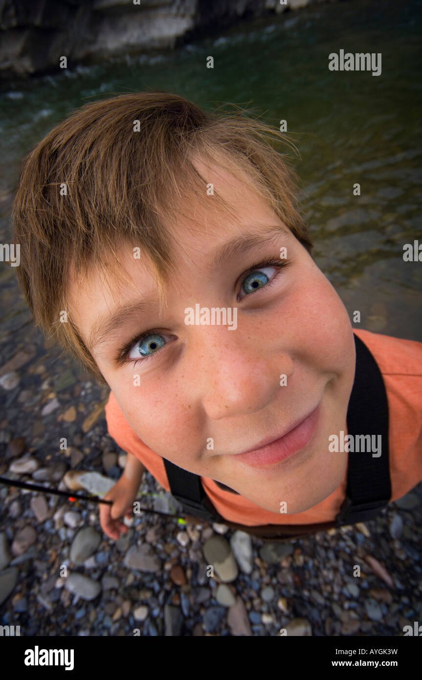 Boy fishing in river Stock Photo - Alamy
