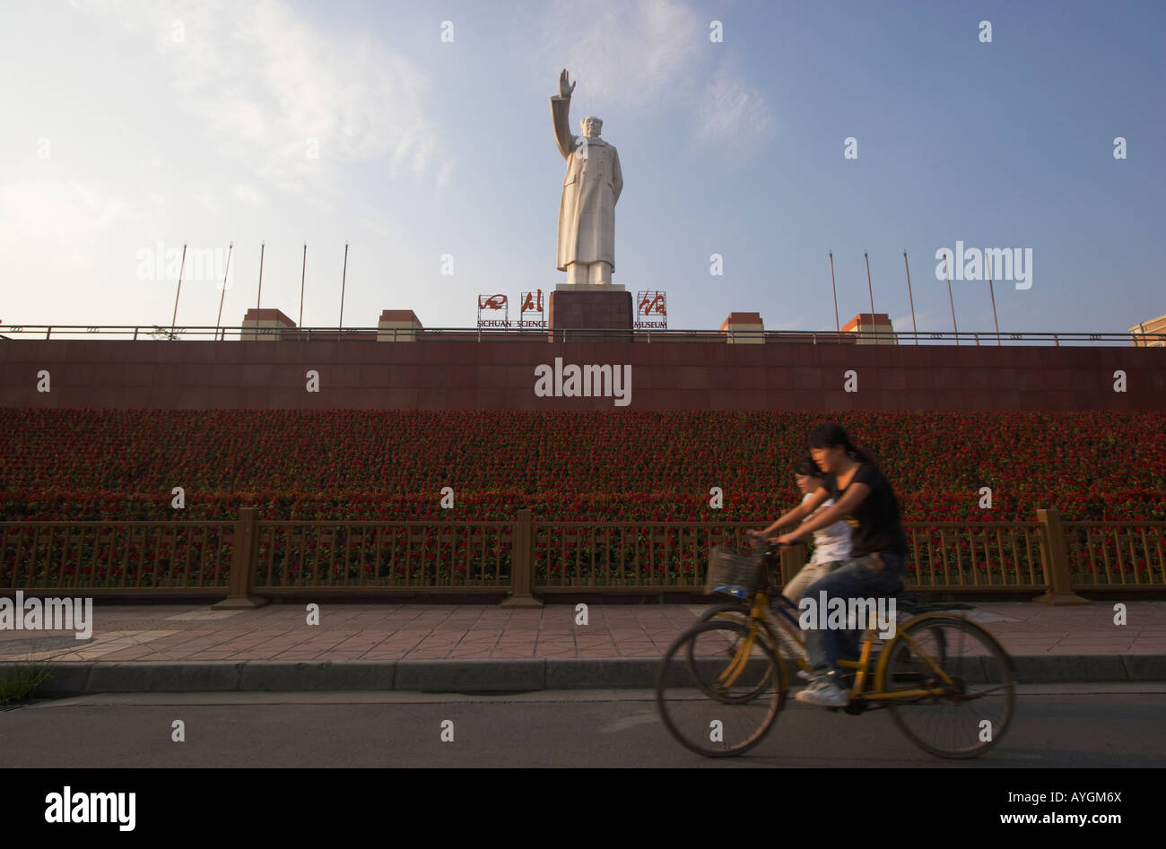 Cyclists Riding Past Mao Zedong Statue In Tianfu Square, Chengdu, China ...