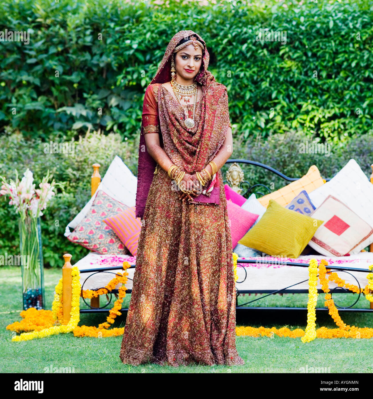 Portrait of a bride in a traditional wedding dress standing in front of ...