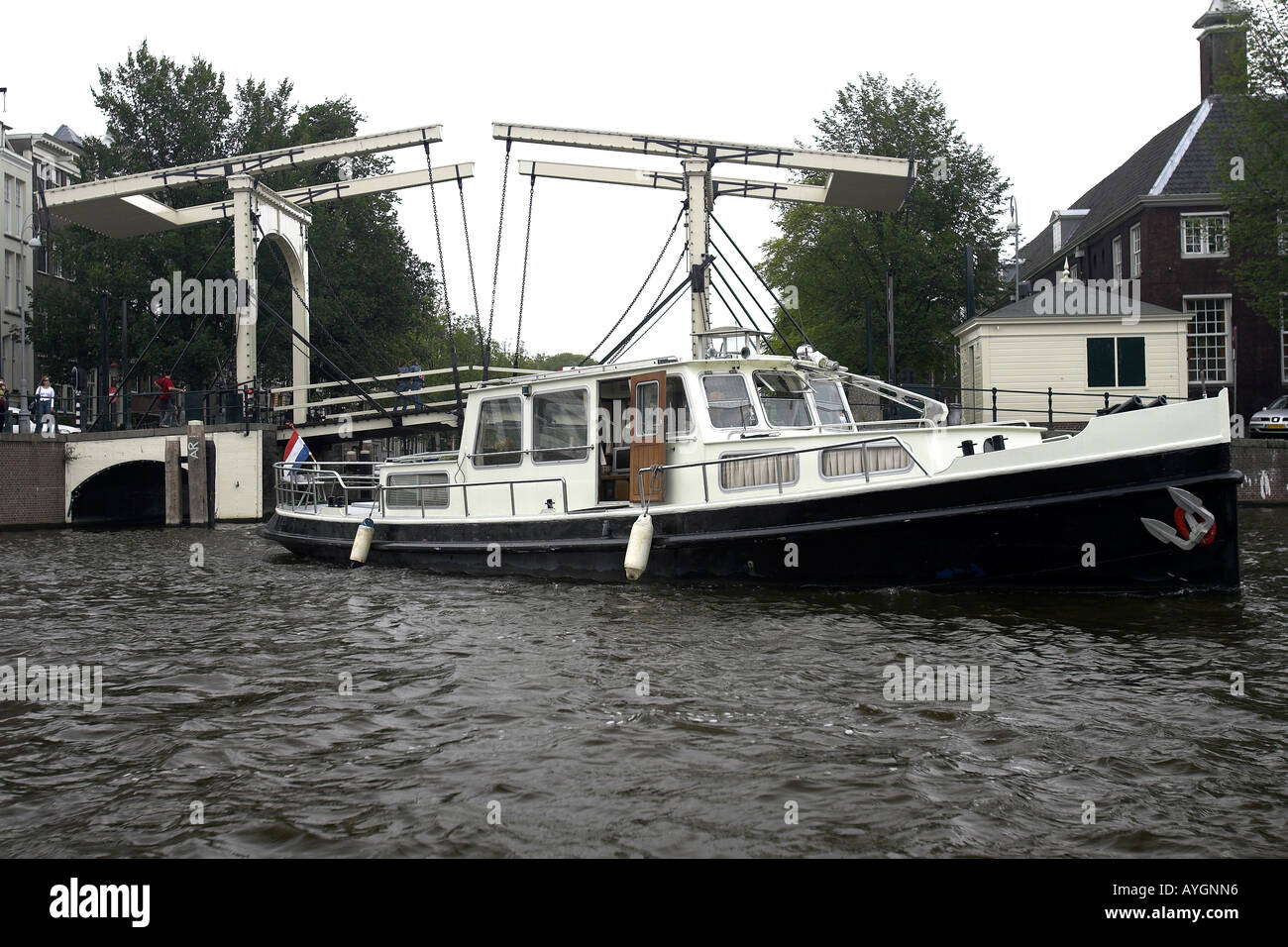 Cruising boat negoiates Amsterdam canal bridge The Netherlands Stock ...
