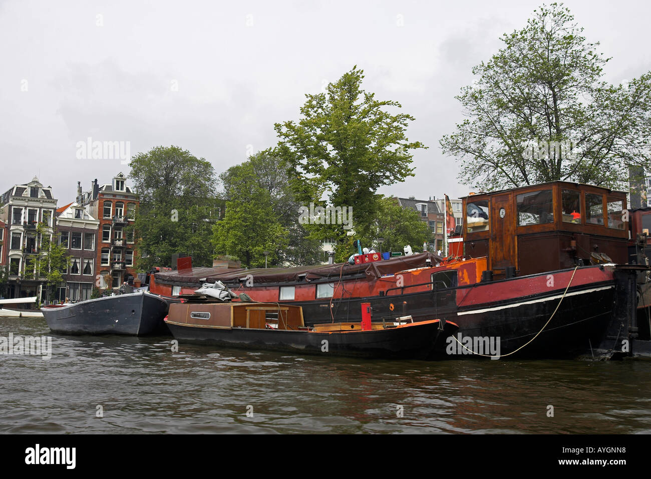 Live aboard boat on Amsterdam canal The Netherlands Stock Photo - Alamy