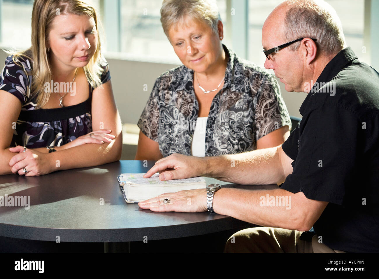 Bible study with three people Stock Photo - Alamy