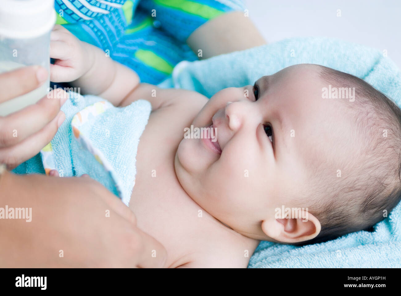 Close-up of a baby girl lying in her mother's lap Stock Photo - Alamy