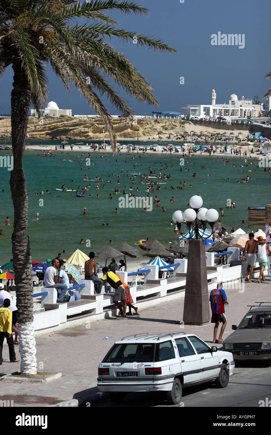 Palm frames holidaymakers cooling off in water Monastir Beach Tunisia ...