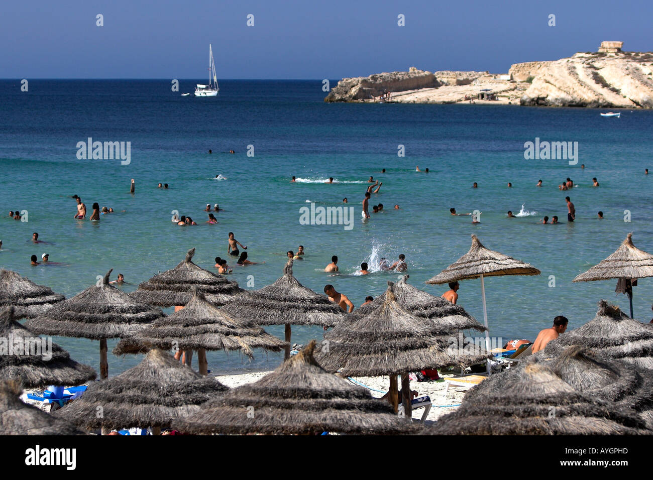 Thatched sunshades line Monastir Beach where holiday makers cool off in ...