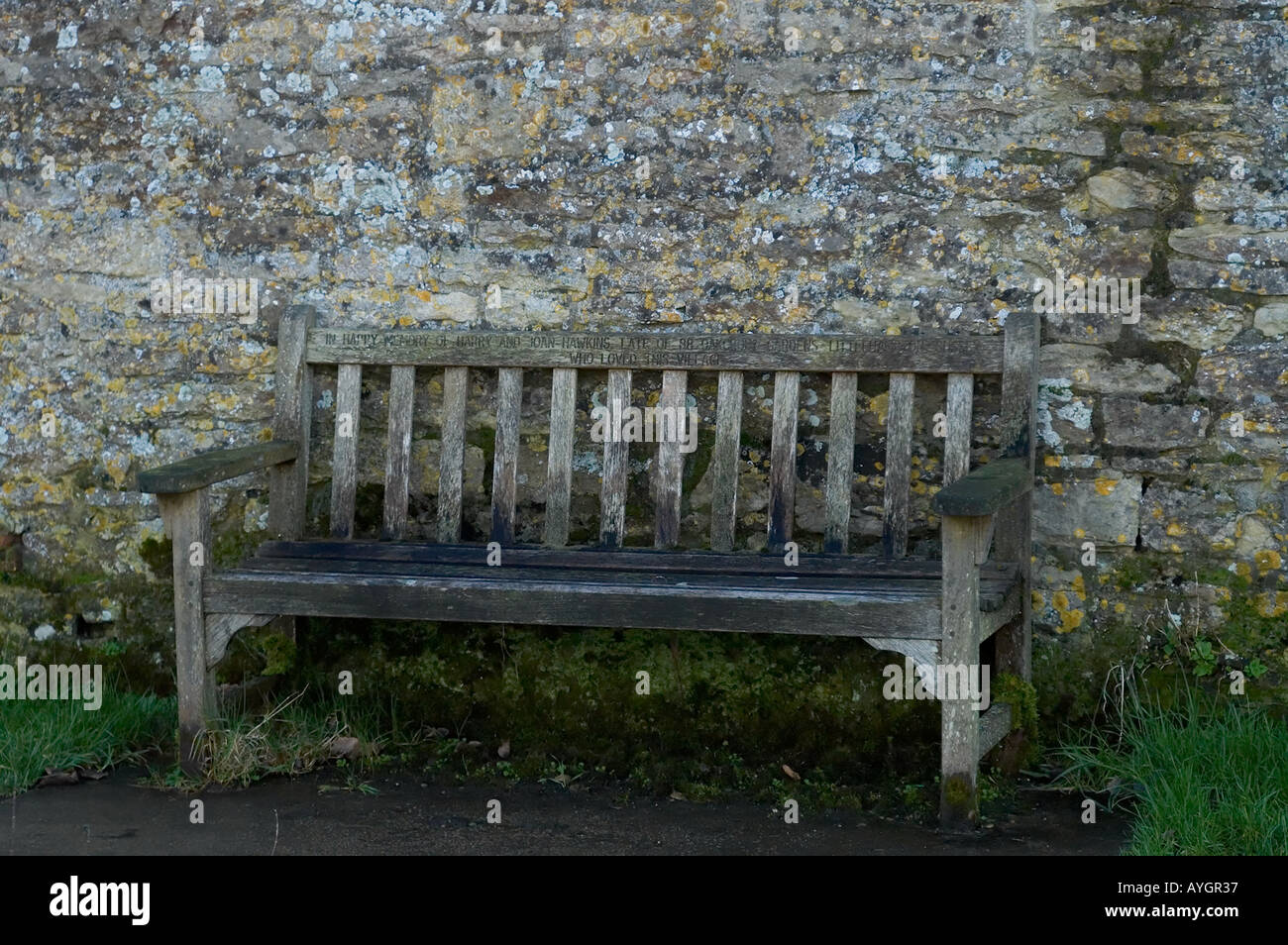 Bench against a cotswold stone wall Stock Photo - Alamy