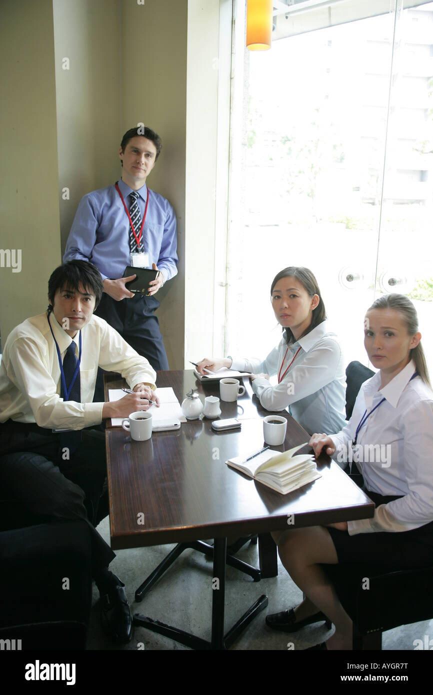 Portrait of four business people in cafe Stock Photo - Alamy