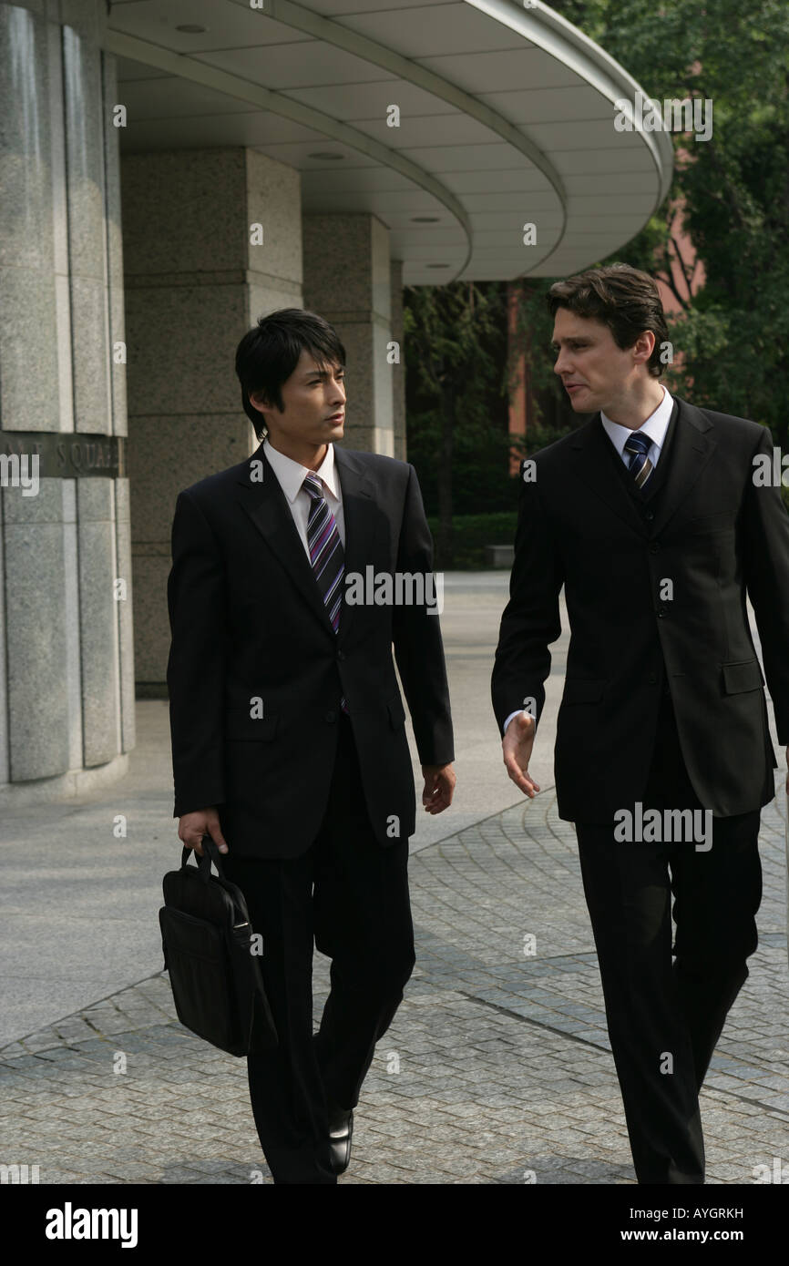 Businessmen walking, outdoors Stock Photo - Alamy