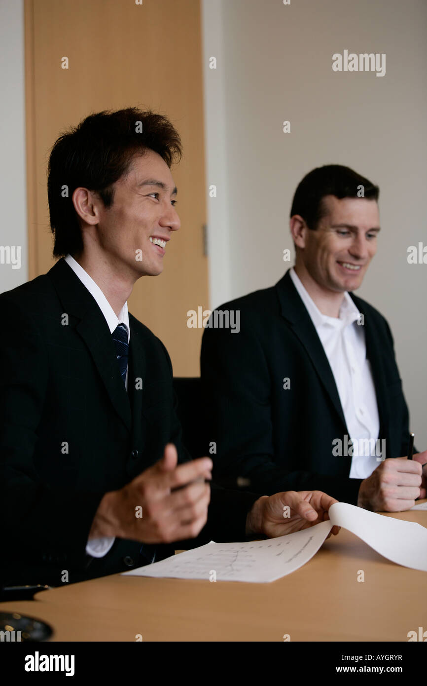 Two businessmen sitting at table Stock Photo - Alamy