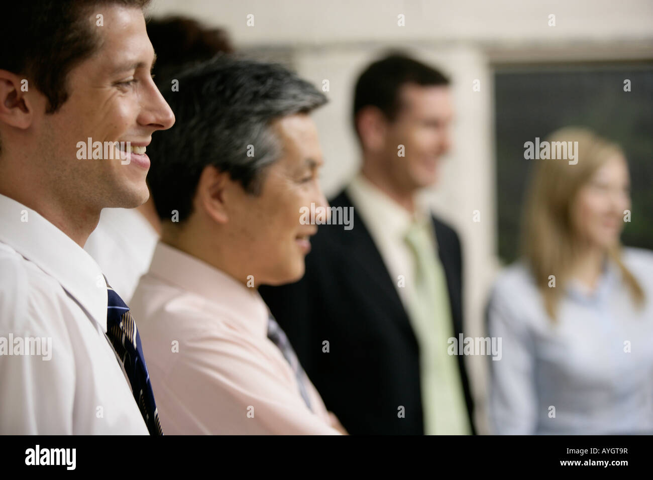 five people standing in conference room Stock Photo - Alamy