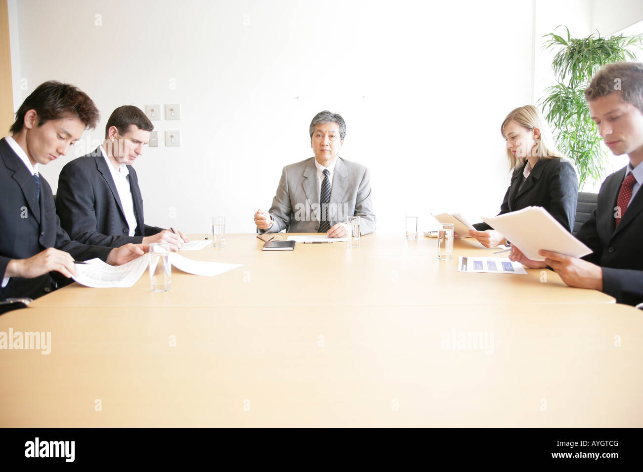 Five business people having business meeting in conference room Stock ...
