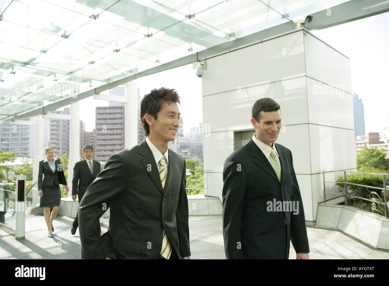 Two business people walking outside office building Stock Photo - Alamy