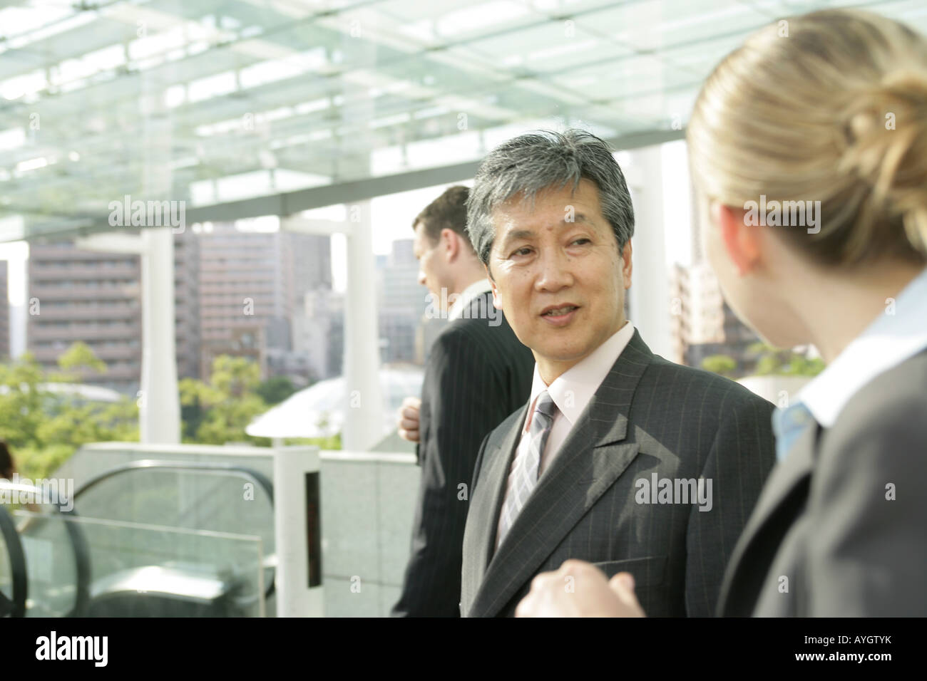 Business couple talking outside office building Stock Photo - Alamy