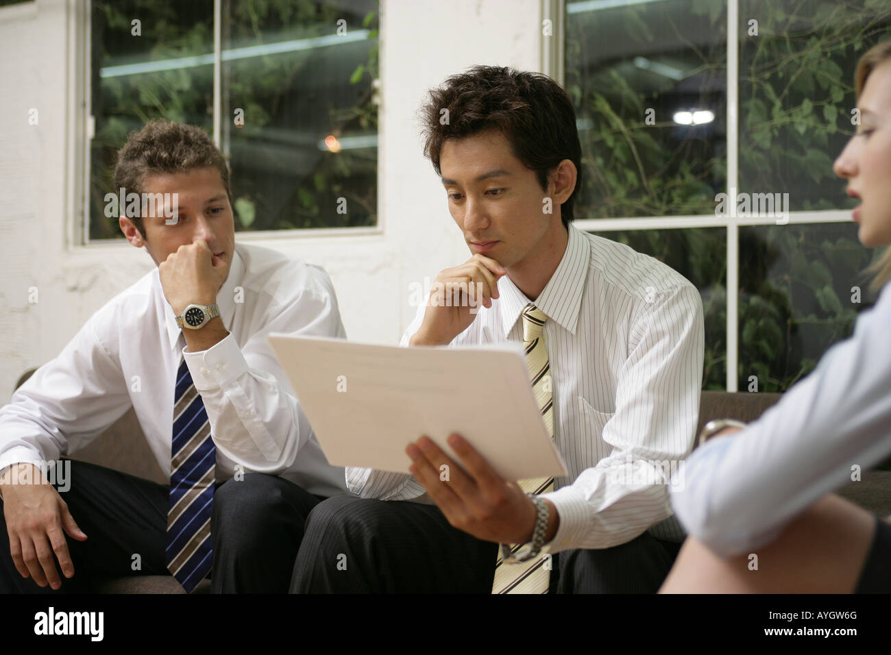 Three businesspeople having meeting Stock Photo - Alamy