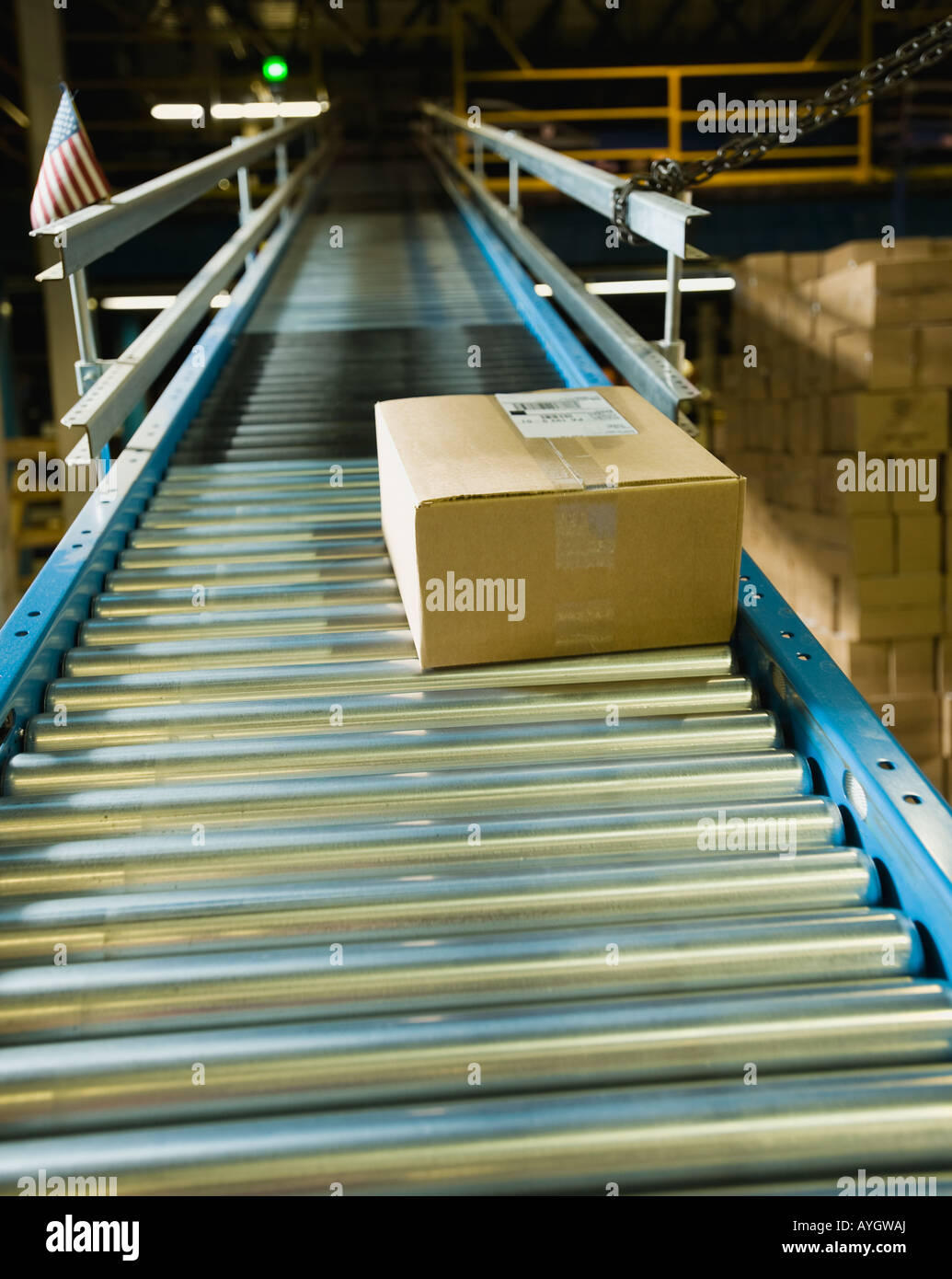 Package on conveyor belt in warehouse Stock Photo - Alamy