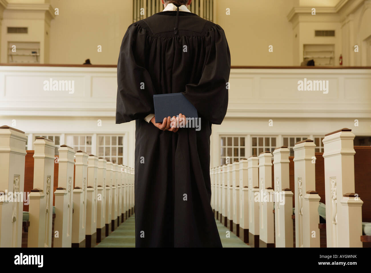 Priest holding bible, back Stock Photo - Alamy