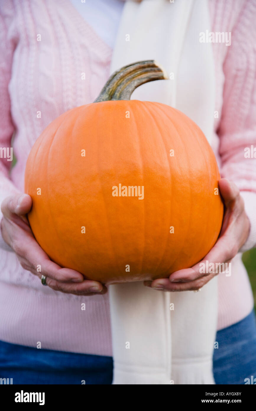 Woman holding pumpkin Stock Photo - Alamy