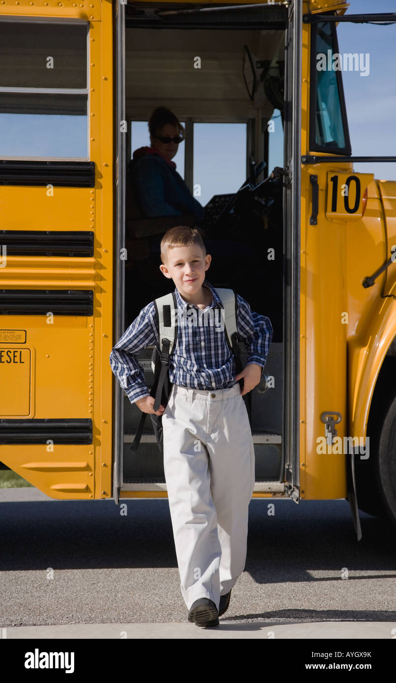 Boy getting off school bus Stock Photo - Alamy