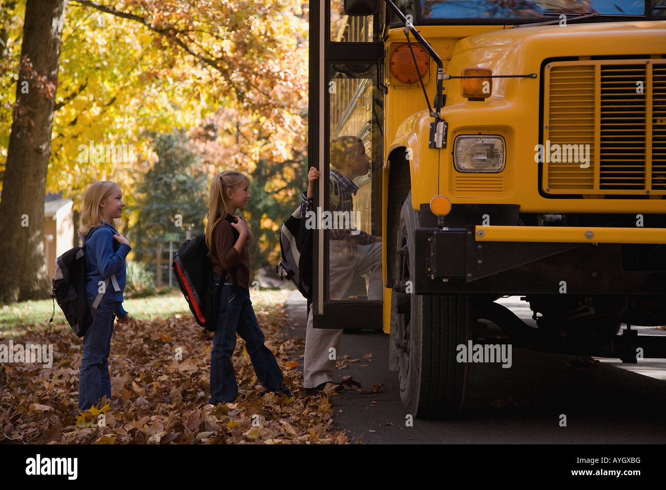 Children getting on school bus Stock Photo - Alamy