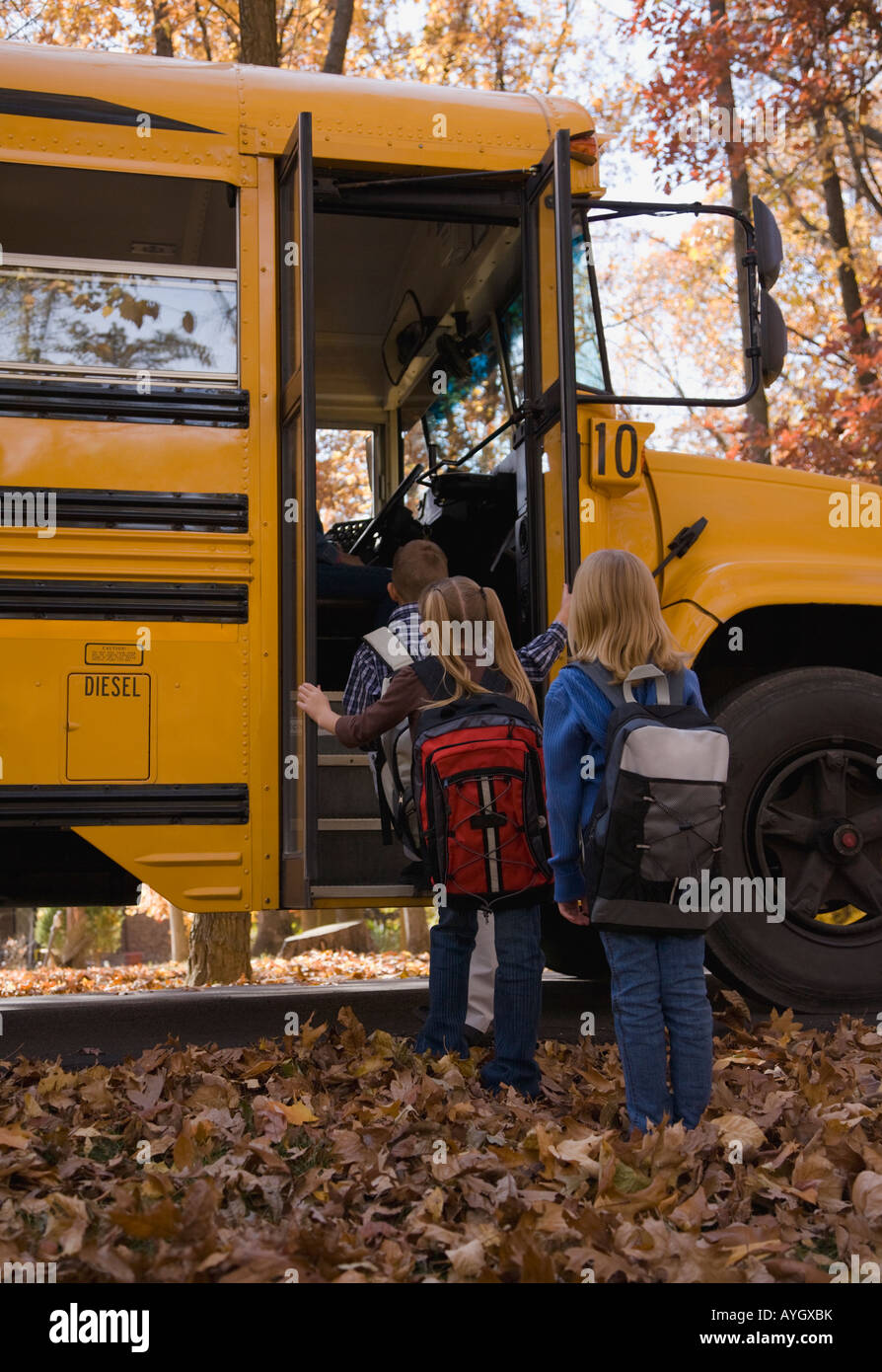 Children getting on school bus Stock Photo - Alamy