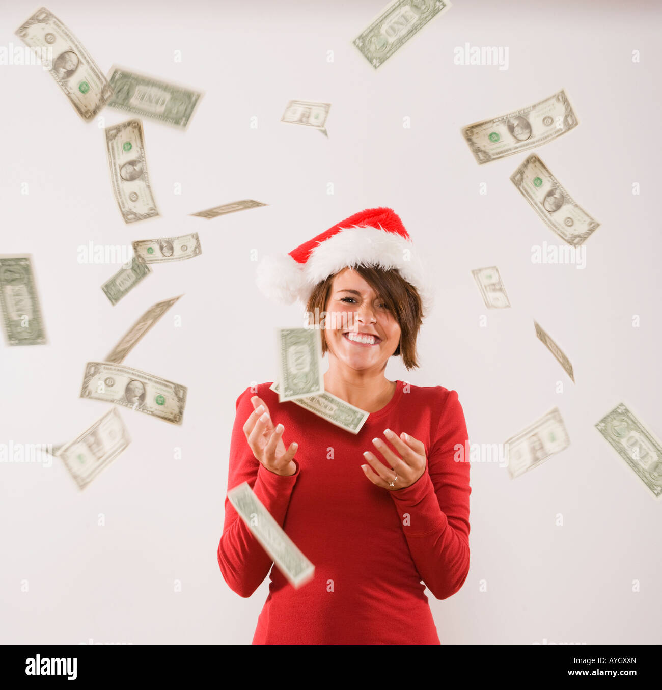Woman smiling money raining down hi-res stock photography and images ...