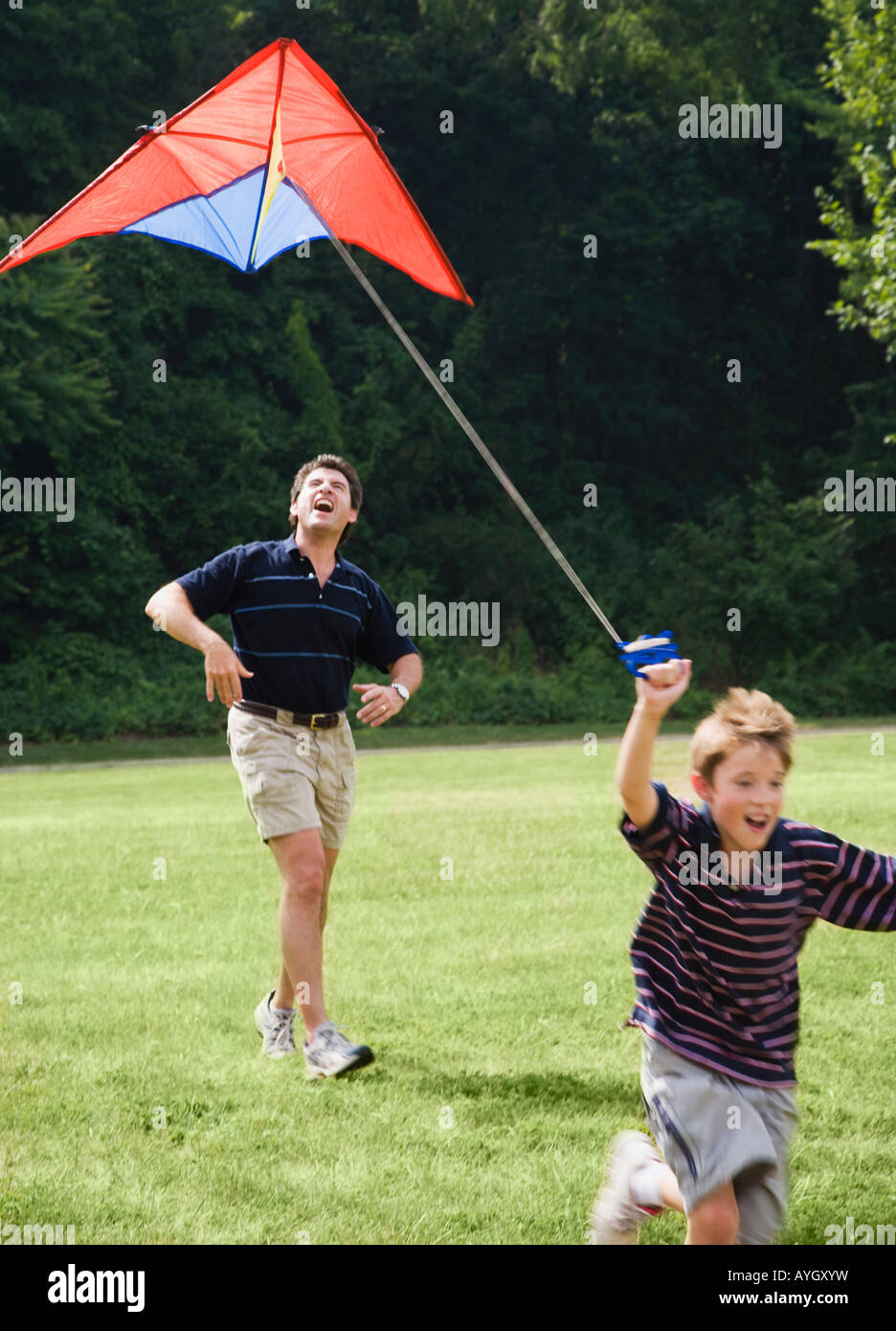 Father and son flying kite Stock Photo - Alamy