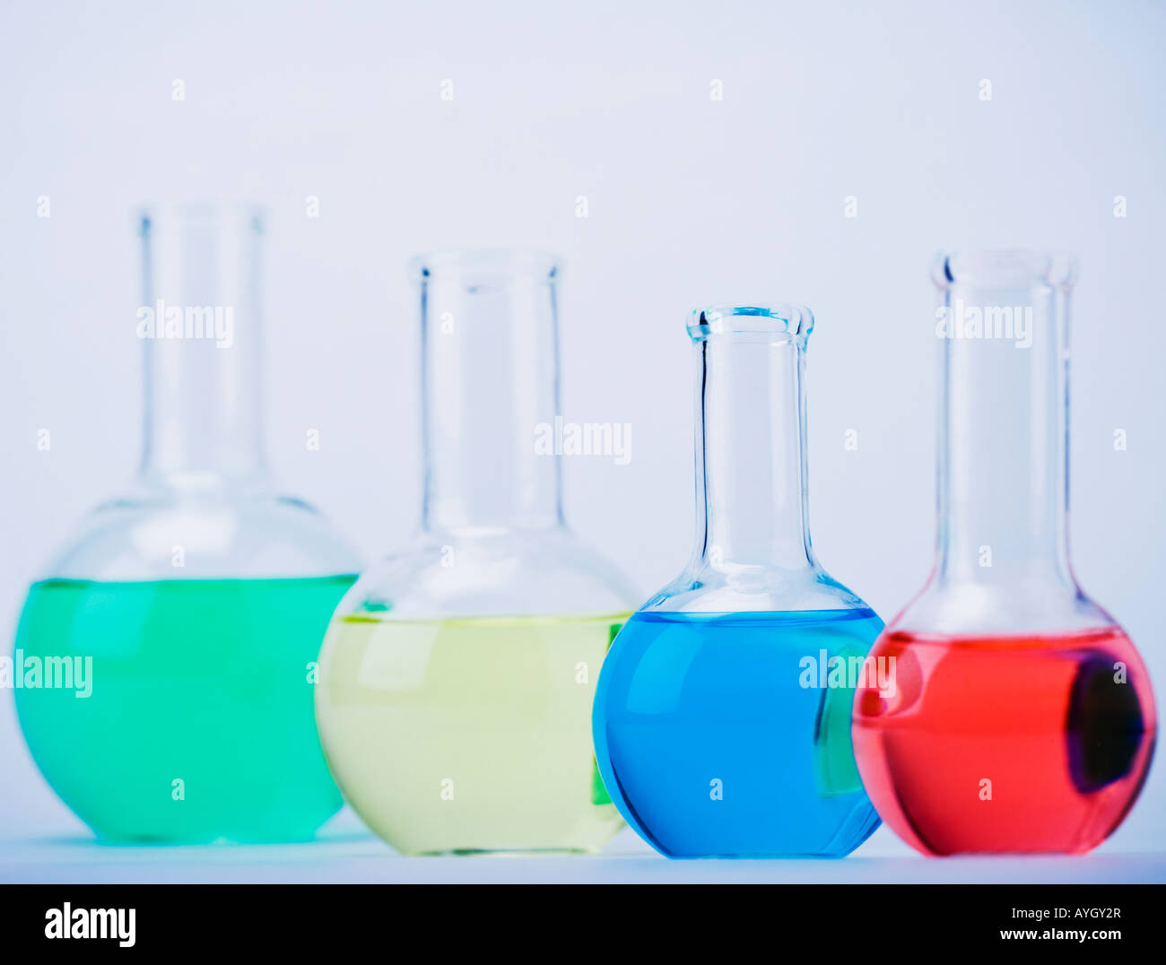 Row of beakers with liquid Stock Photo - Alamy