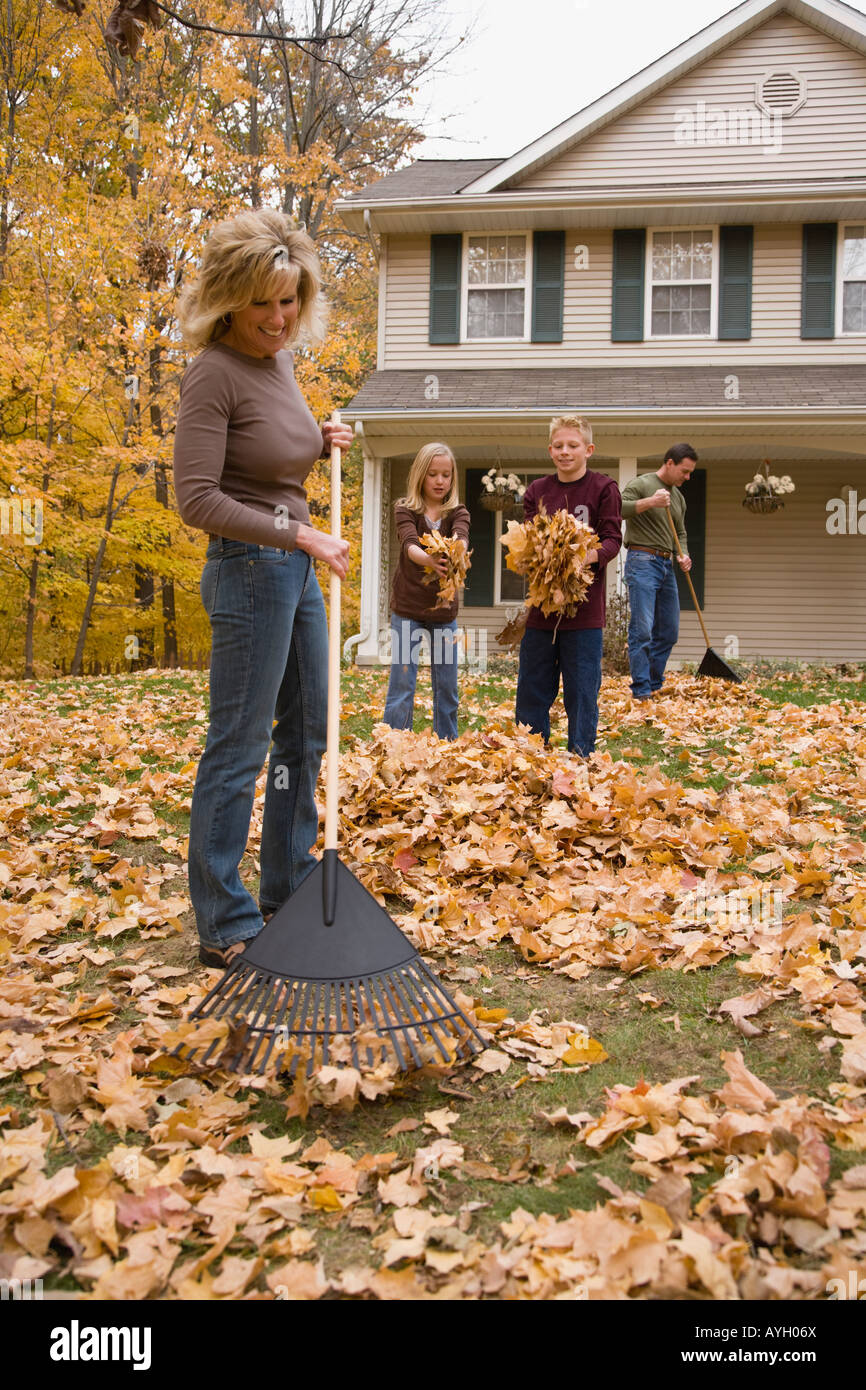 Family cleaning up autumn leaves Stock Photo - Alamy
