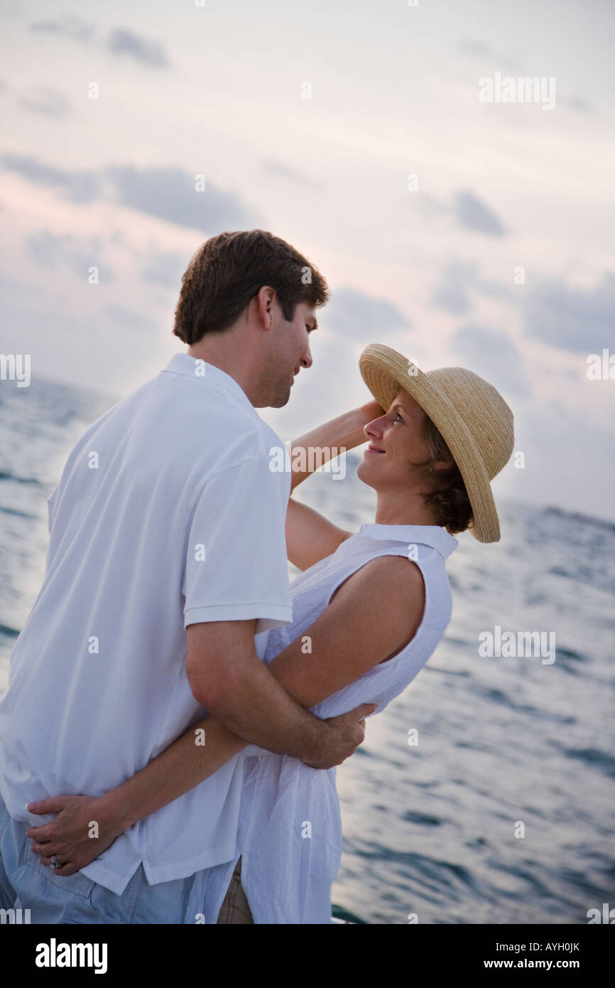 Couple hugging in front of water Stock Photo - Alamy