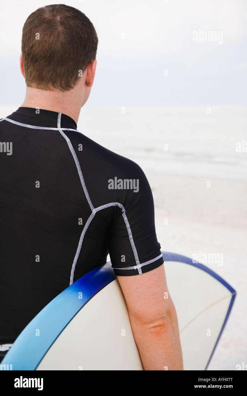 Man holding surfboard Stock Photo - Alamy
