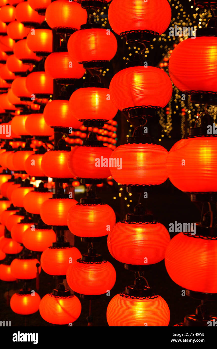 red lanterns hung in rows at night Stock Photo - Alamy