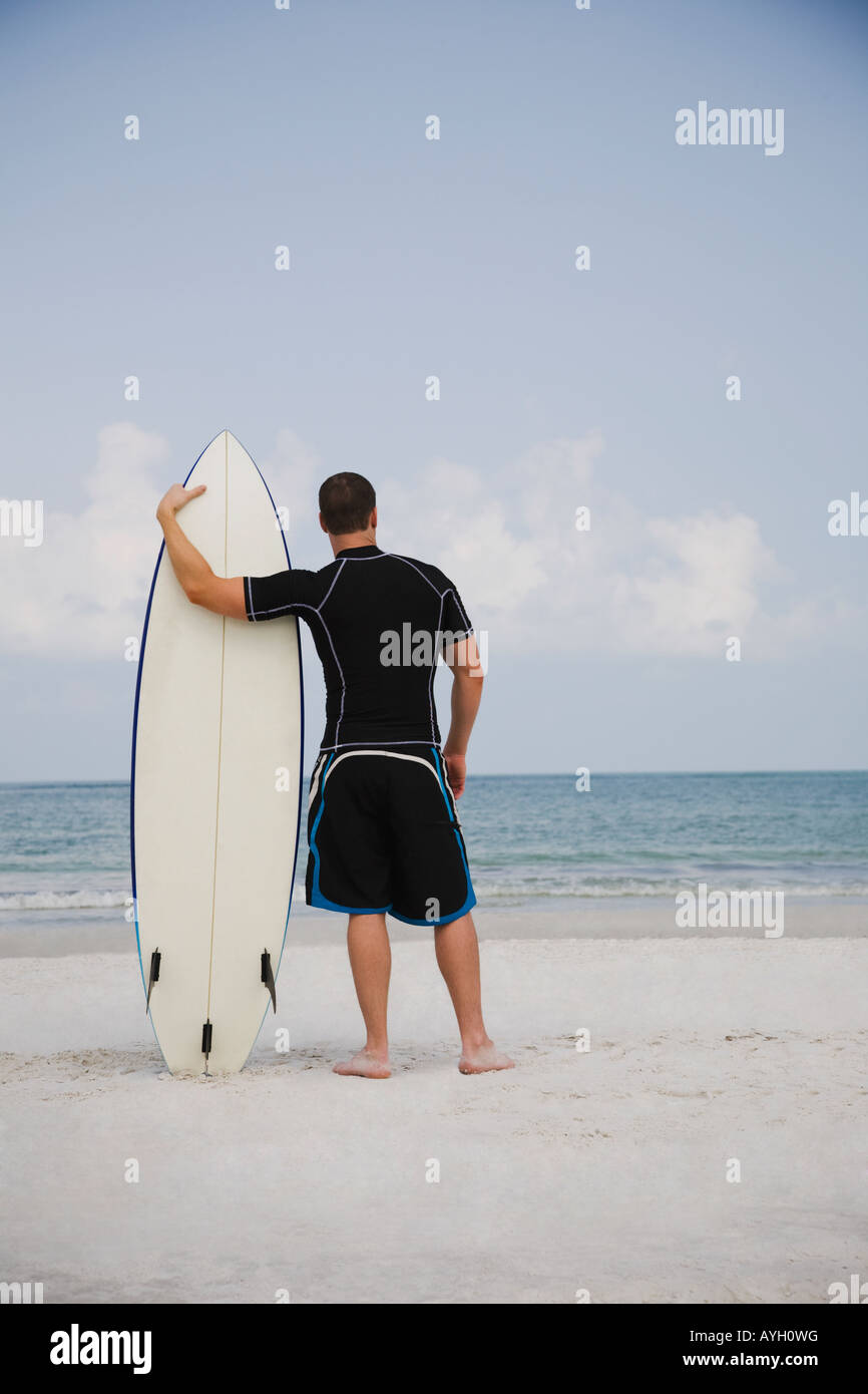 Man holding surfboard Stock Photo - Alamy