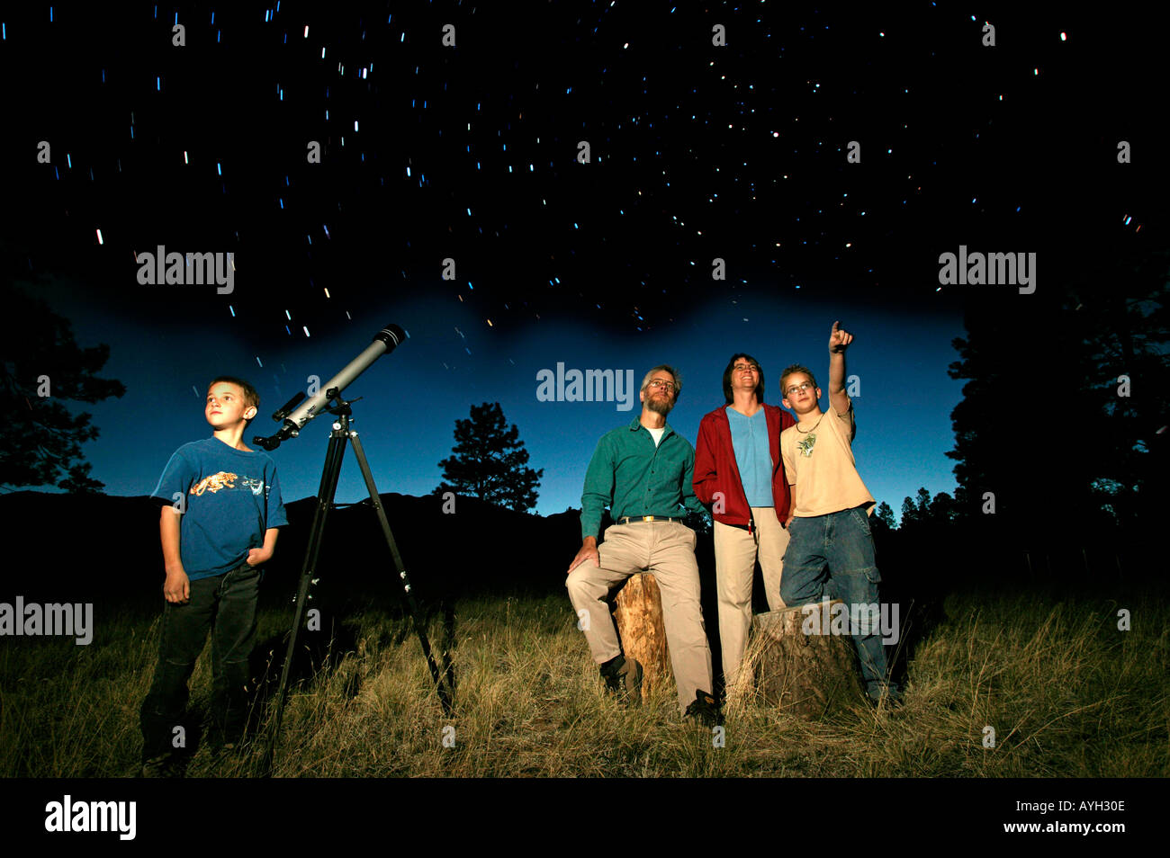 family spends an evening stargazing with their telescope Stock Photo ...