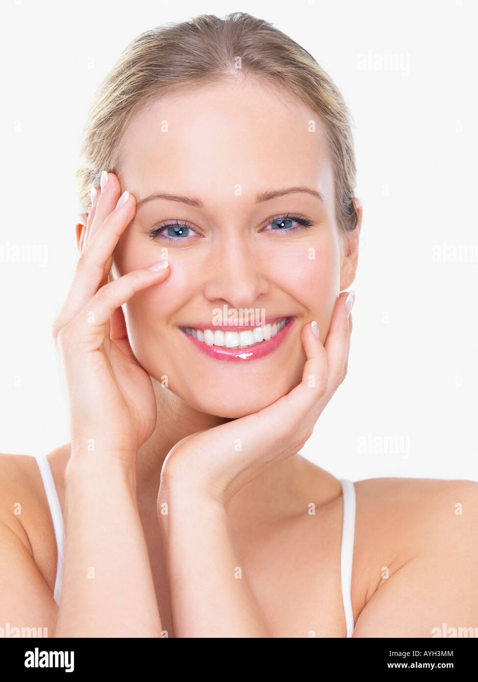 Woman with hands on face Stock Photo - Alamy