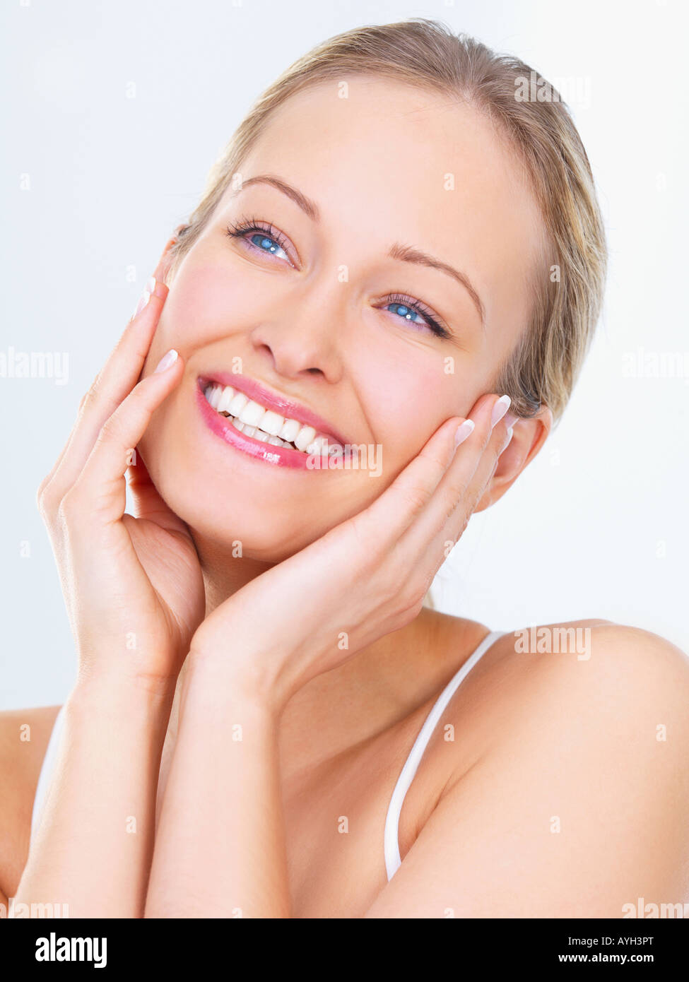 Woman with hands on cheeks Stock Photo - Alamy