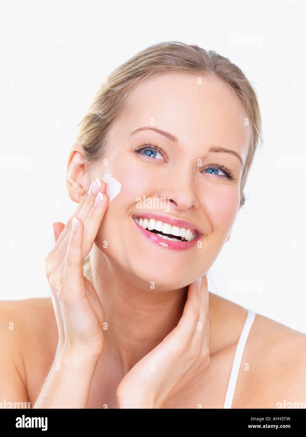Woman applying face cream Stock Photo - Alamy