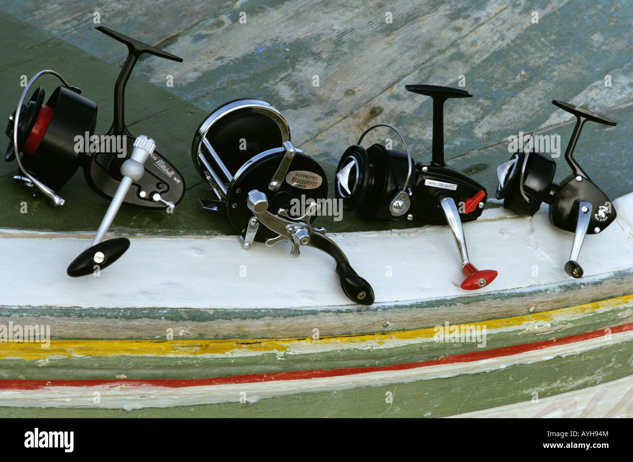 Fishing rod reels displayed on rowing boat Stock Photo - Alamy