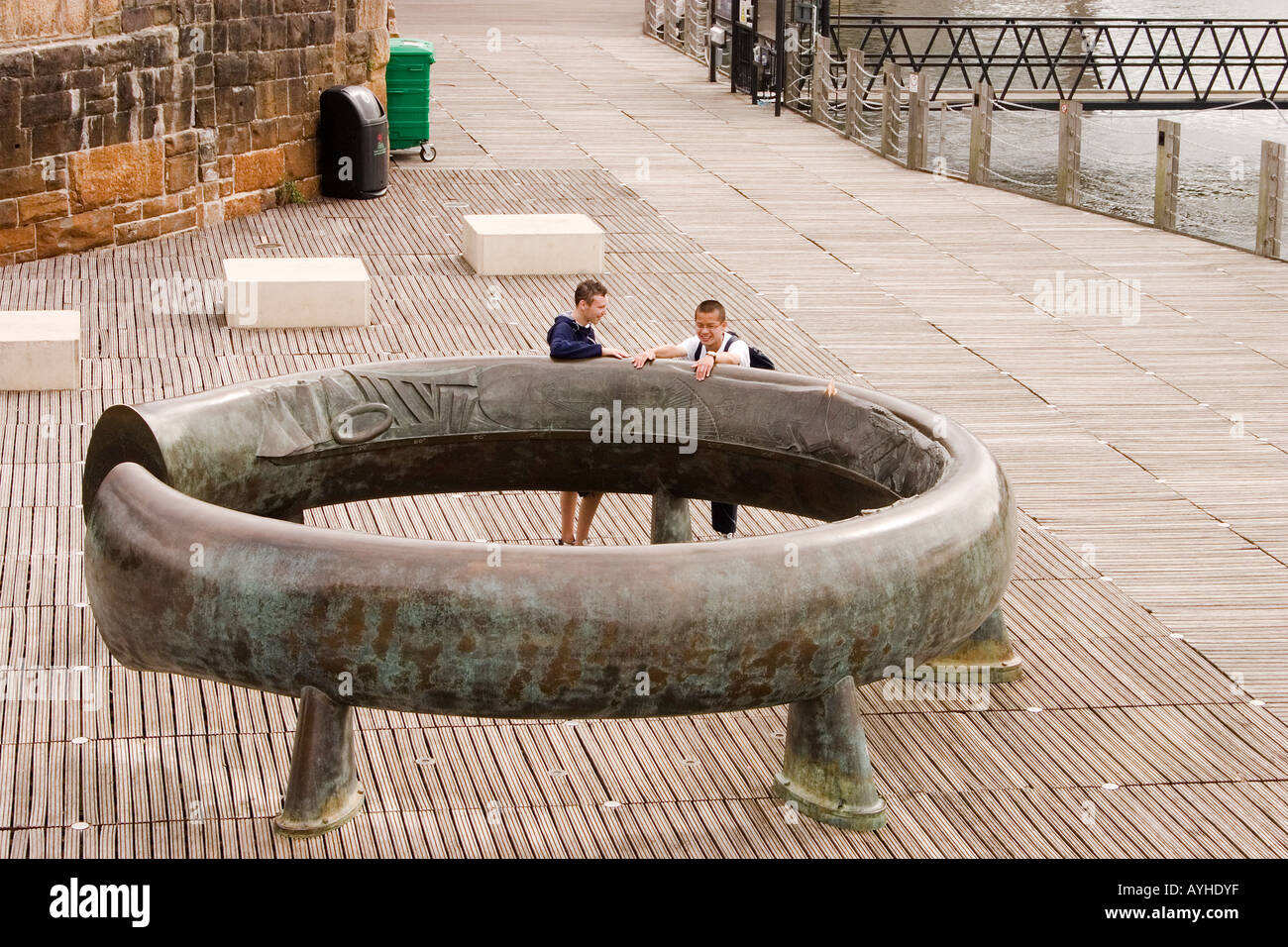Teenagers at the bronze torque sculpture on the Boardwalk at the mouth ...