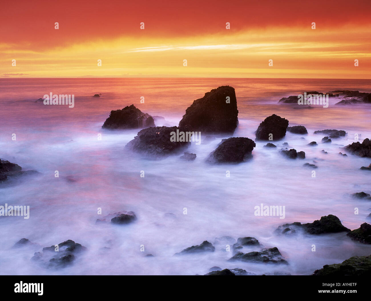 Waves painting rocks and sandy shore at sunset at Woods Cove in Laguna ...